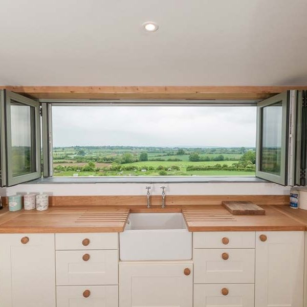 Wooden window - Moving Designs Ltd - aluminum / PVC / folding