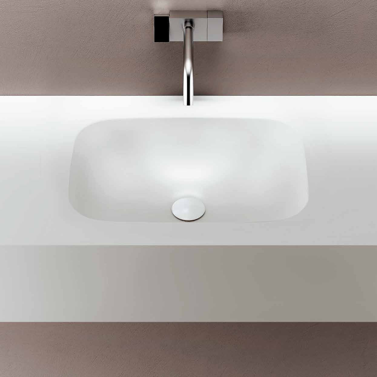 Integrated washbasin - STELLA - PLANIT - Corian® / with counter / custom