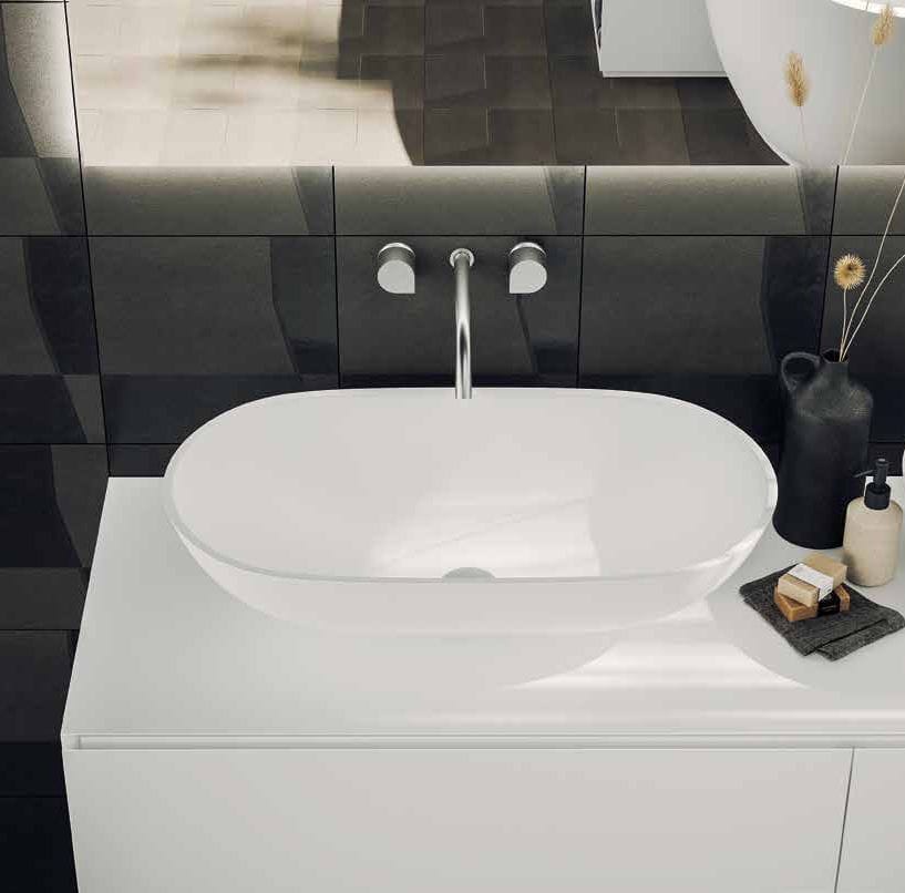 Countertop washbasin - CONCAVE - PLANIT - Corian® / oval / without hole