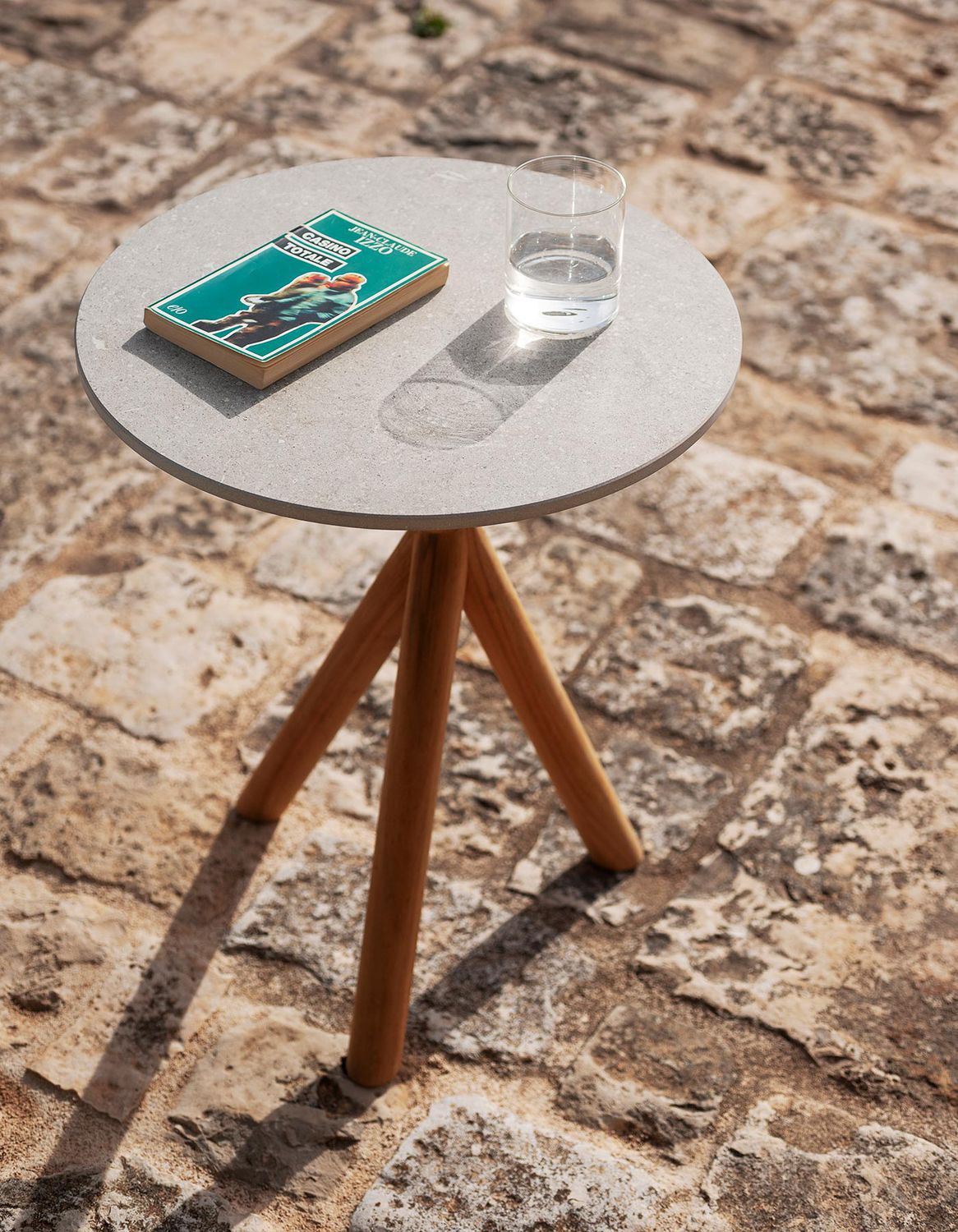 Contemporary side table - STORK - RODA - sandstone / teak base / round