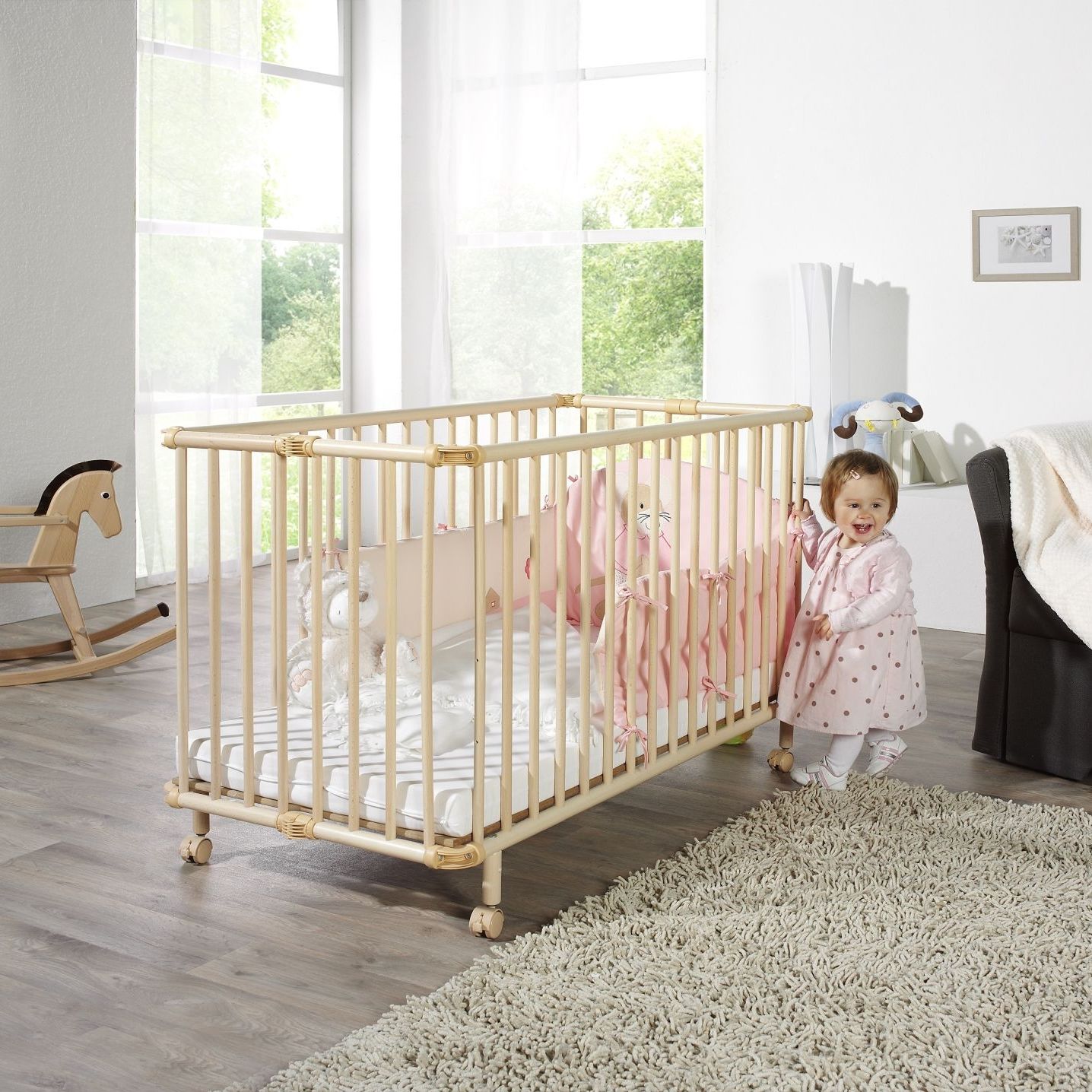 Contemporary baby bed - MAYLA - Geuther - on casters / folding / wooden
