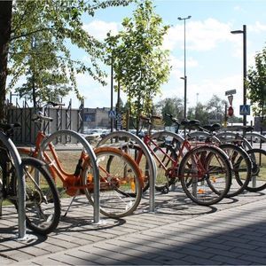 Floor-mounted bike rack - TUBE - GUYON - metal / iron / polyester